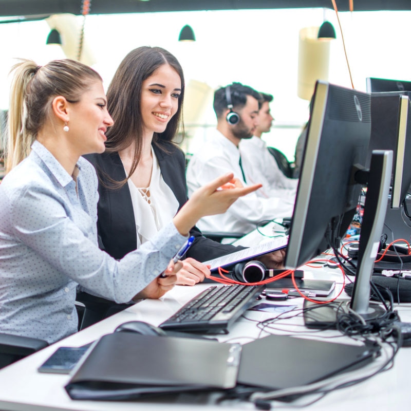 Professional female staff analyzing strategy of their work on desktop ...